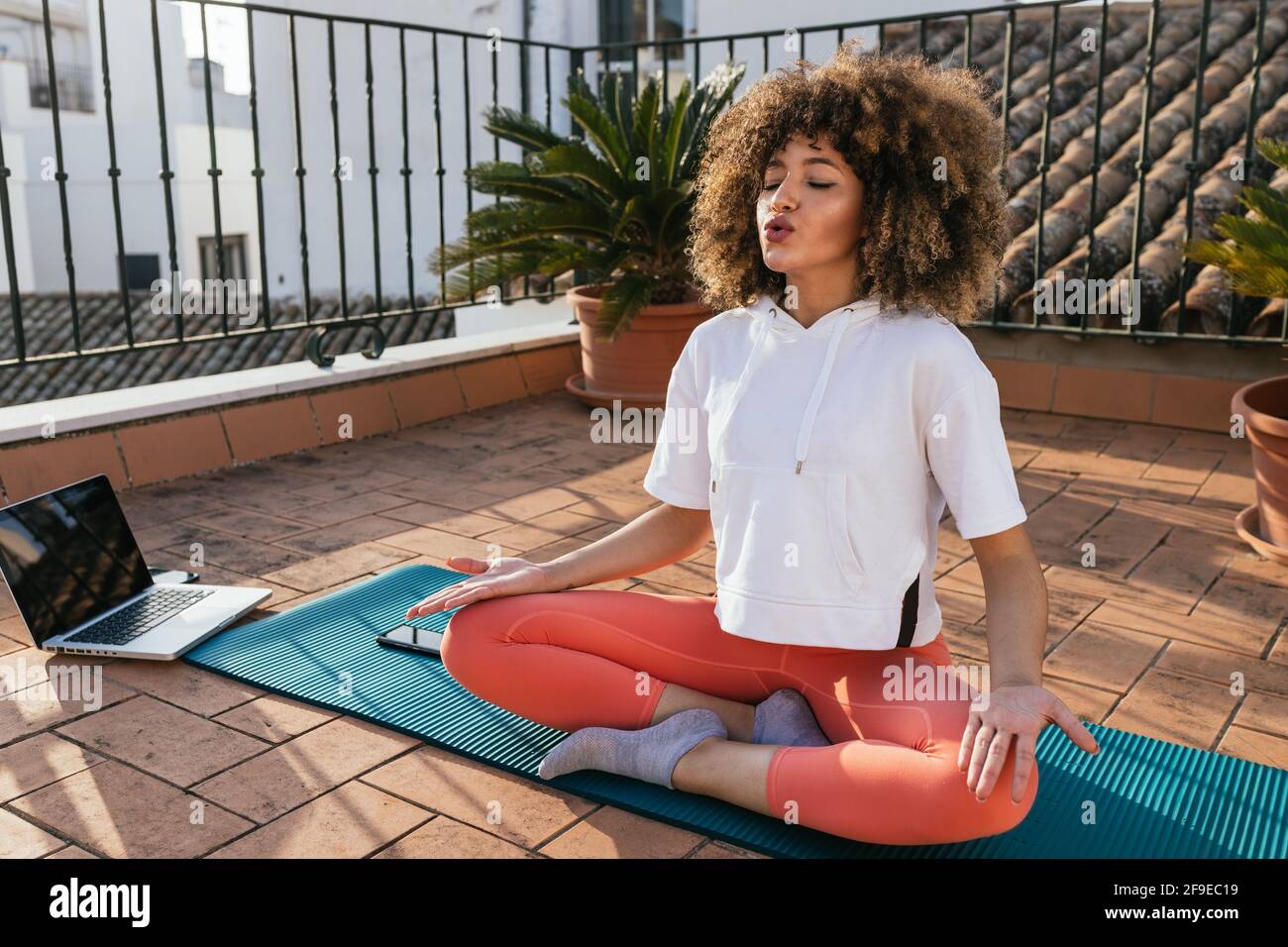 Tranquil African American female sitting meditating with closed eyes ...