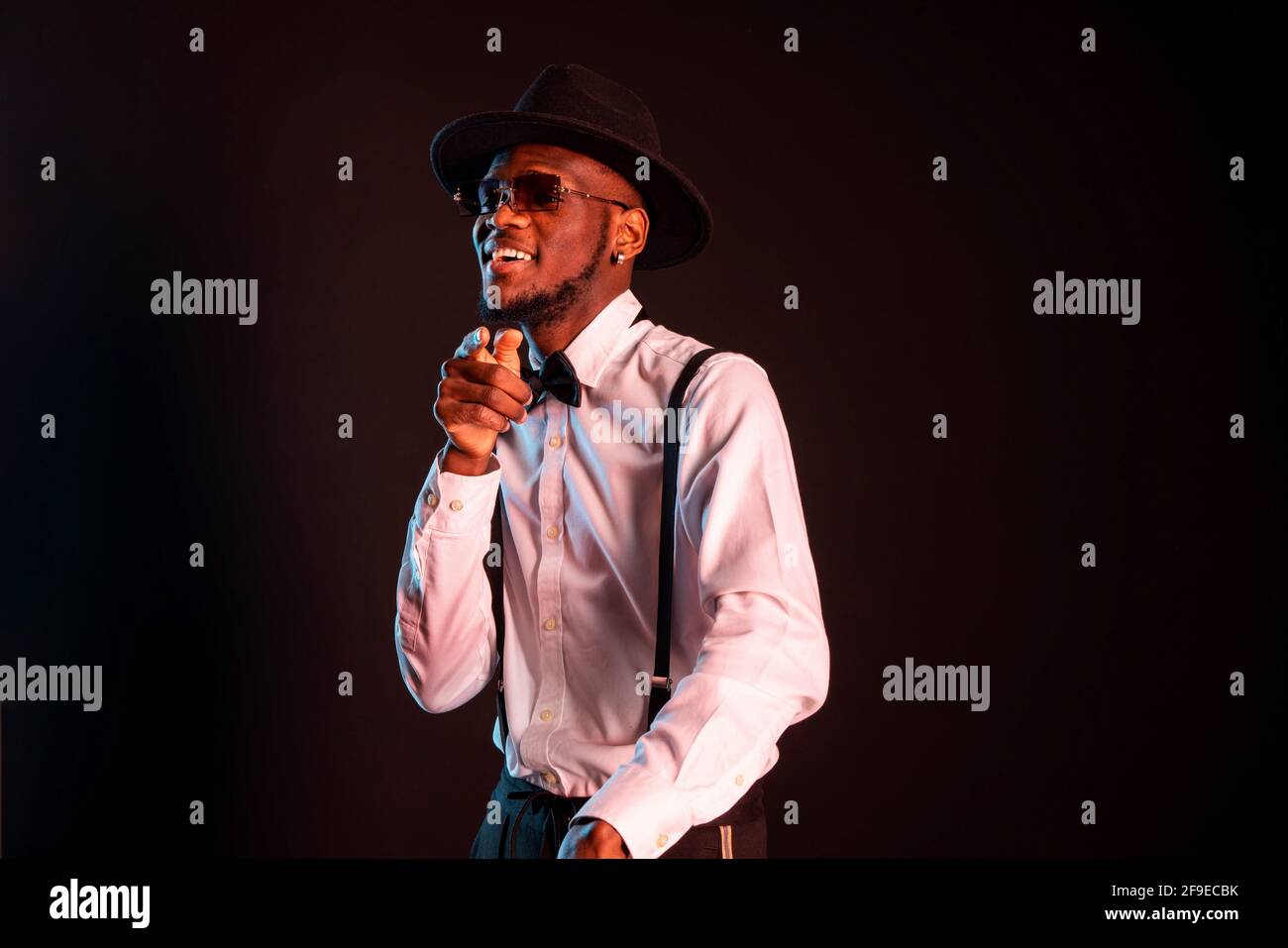 Back view full body of painter with spray paint making graffiti hanging ...