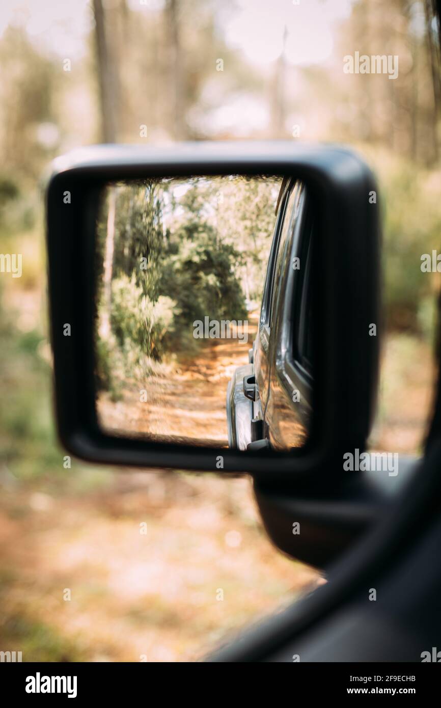 Rear view of an off-road car driving through a mountain road Stock ...