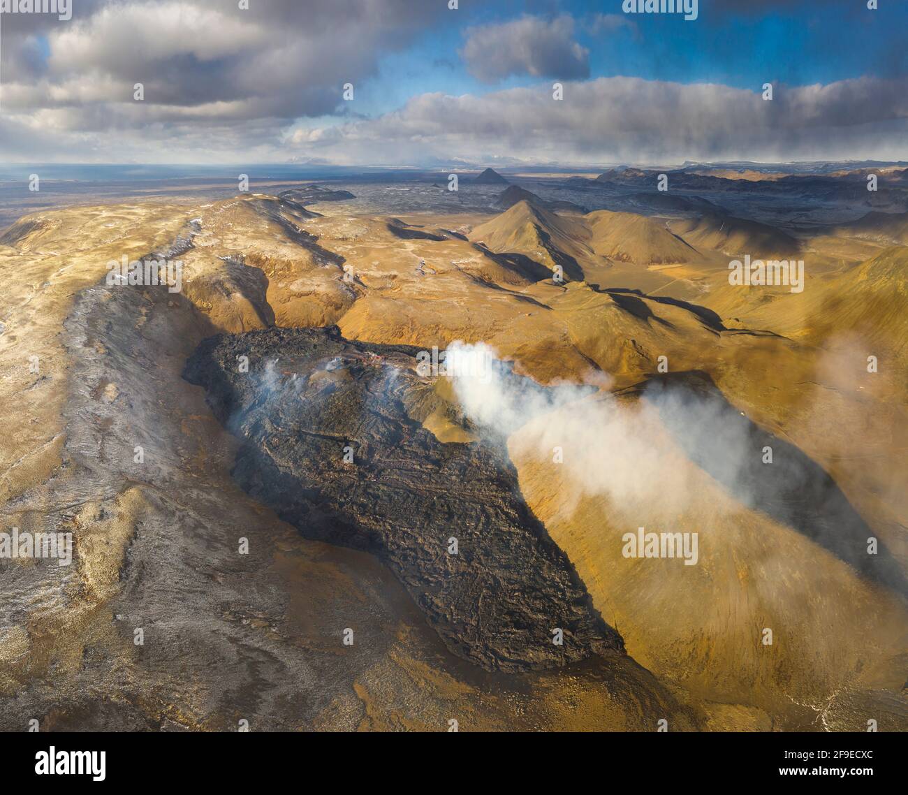 From above columns of smoke and magma sparks out of the volcano hole ...
