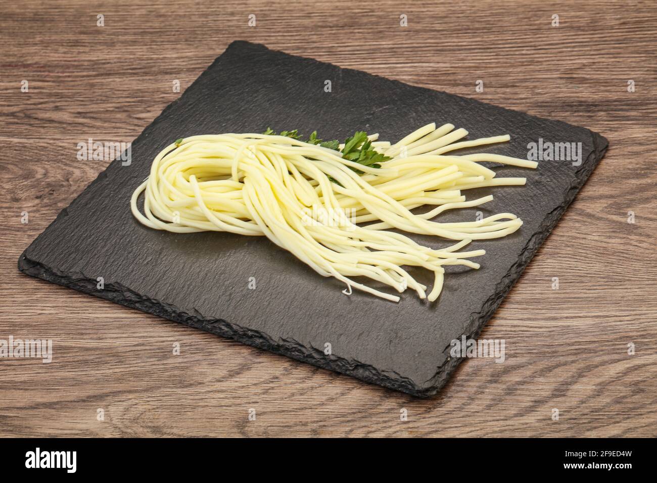 Chechil spaghetti cheese snack over board Stock Photo - Alamy