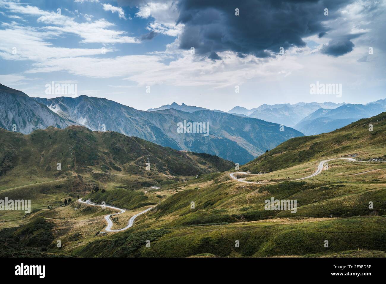 Landscape of Aran valley with majestic green hills and dark gray gloomy ...