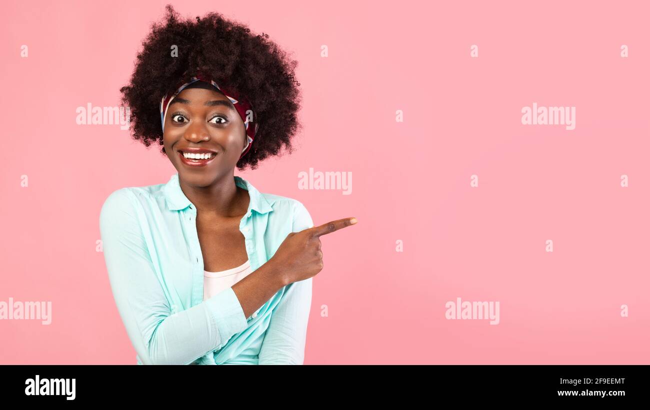 Smiling afro american woman pointing hi-res stock photography and ...