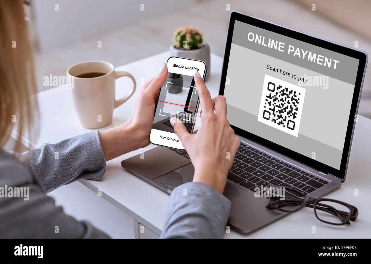 Unrecognizable woman scanning qr code by smartphone from laptop Stock ...