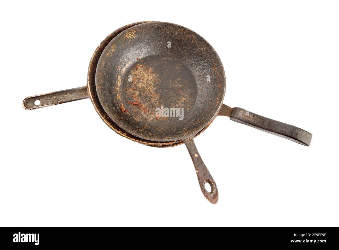 old disgusting stained rusty cast iron pan stack with burnt fat and ...