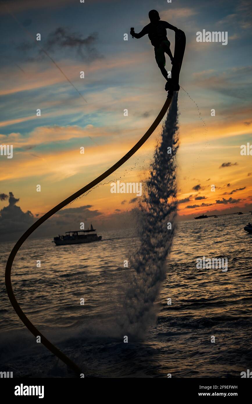A silhouette of a man flyboarding at suns Stock Photo - Alamy