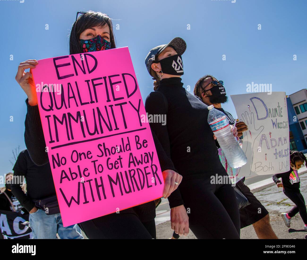 A protestor holding a placard expressing her opinion, during the march ...