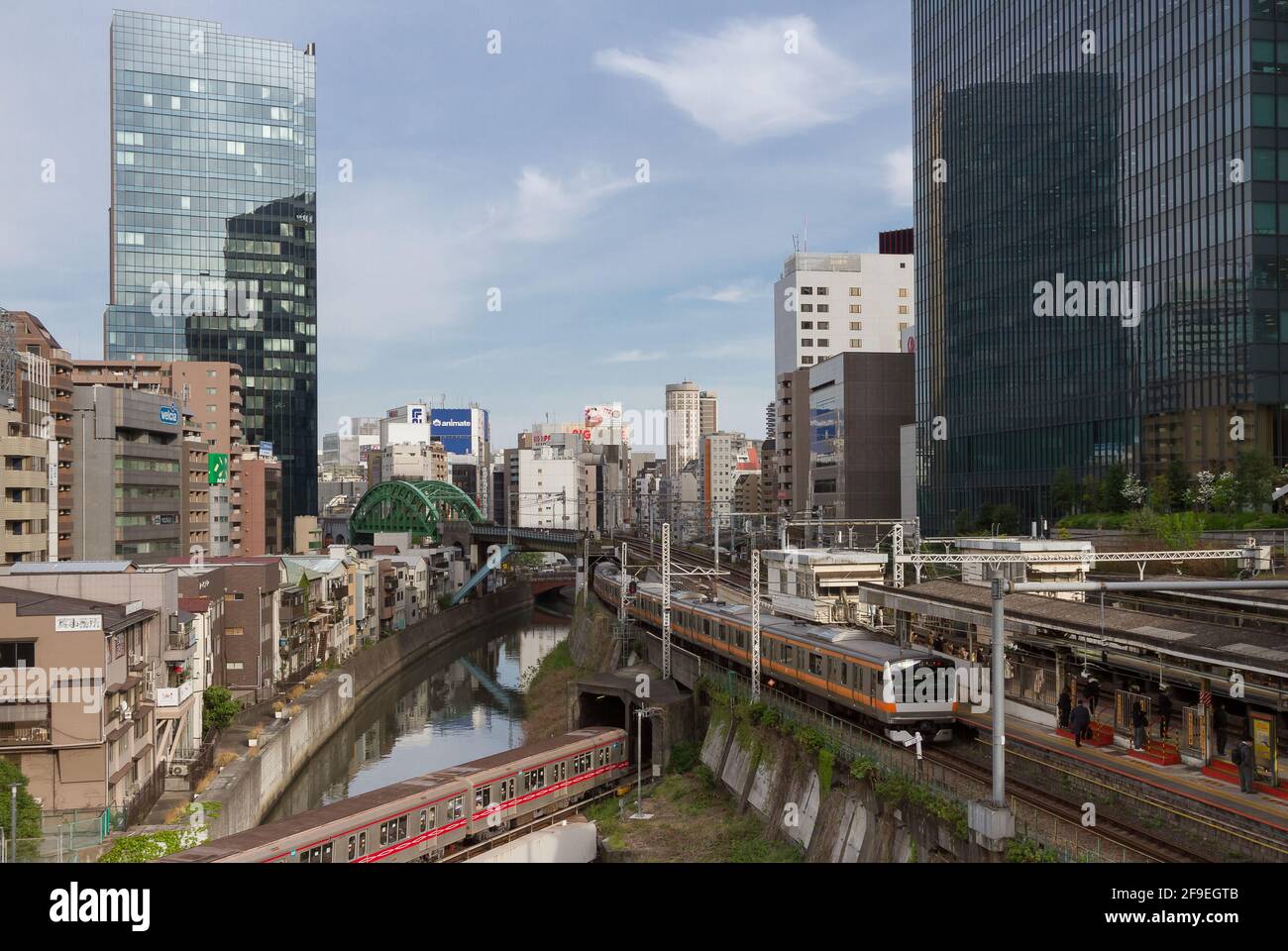 A Tokyo Metro 02 series train on the Marunouchi Line passes under a ...