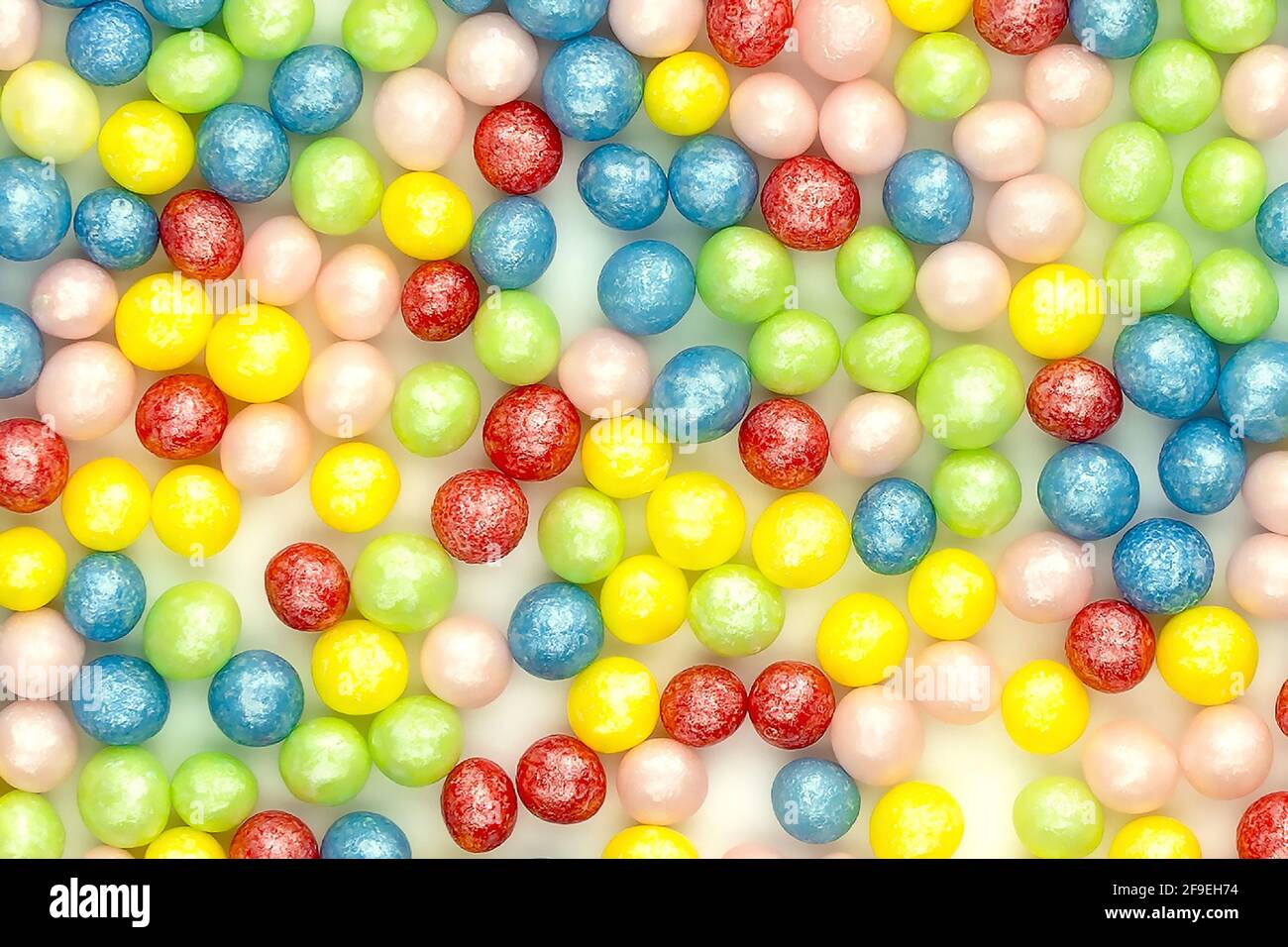 Background from multicolored shiny candy. Bright sweets round beads for ...