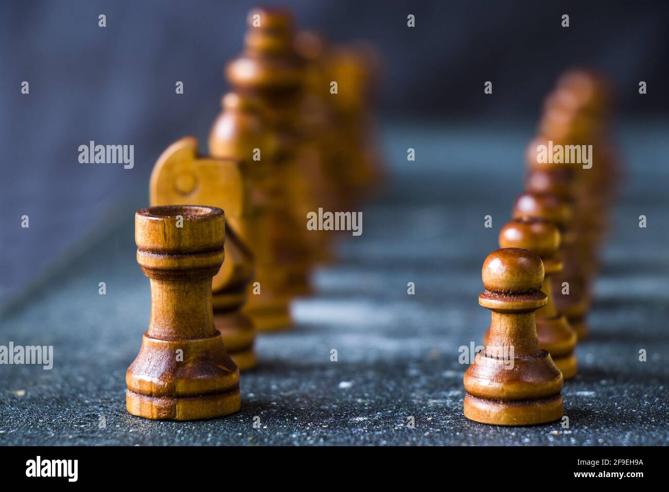 A selective focus shot of wooden chess brown figures in starting ...