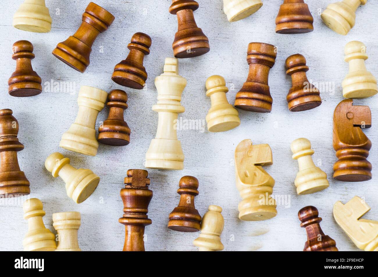 A top view of fallen wooden chess figures on a white table Stock Photo ...