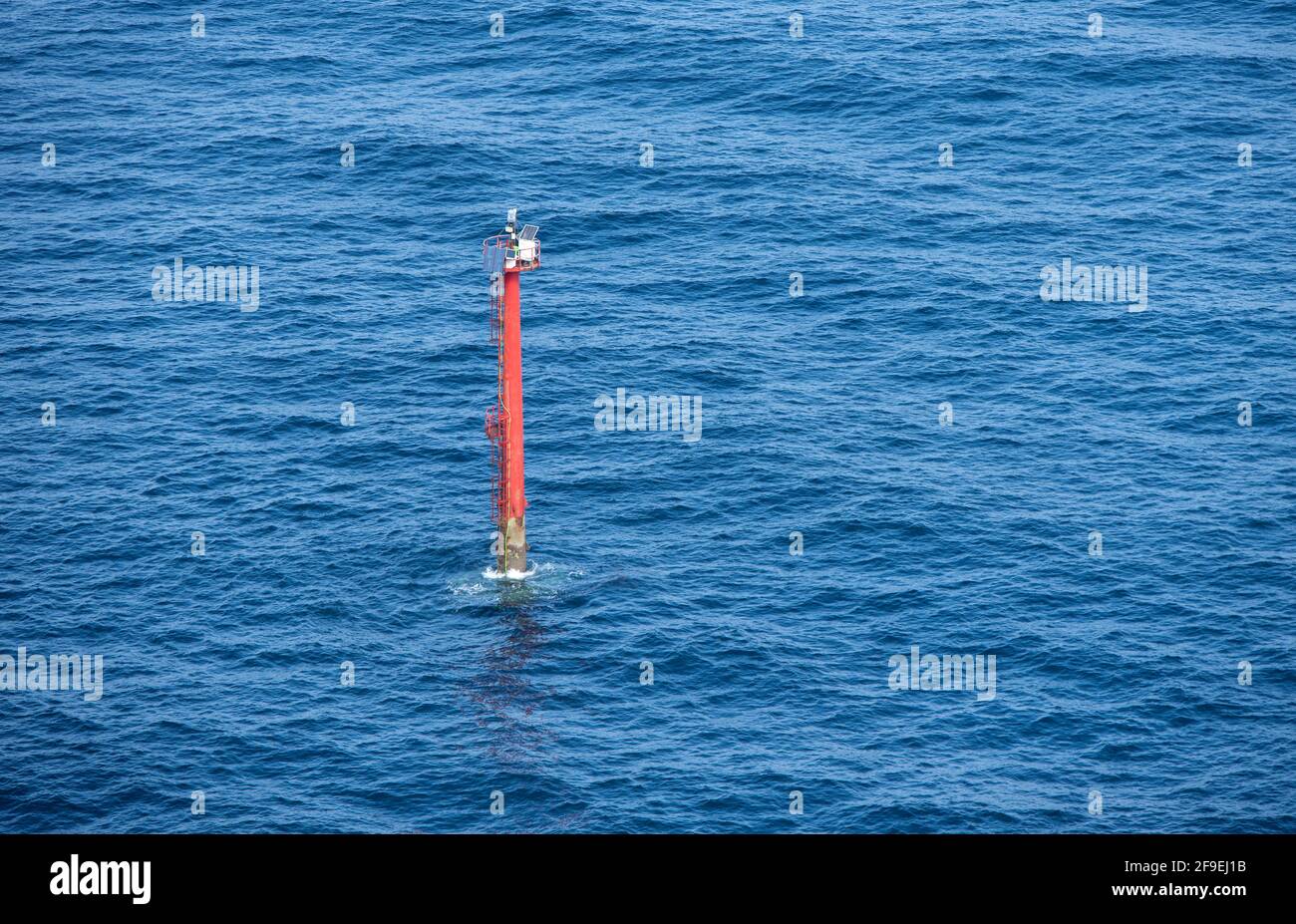 lighthouse in the blue ocean Stock Photo - Alamy