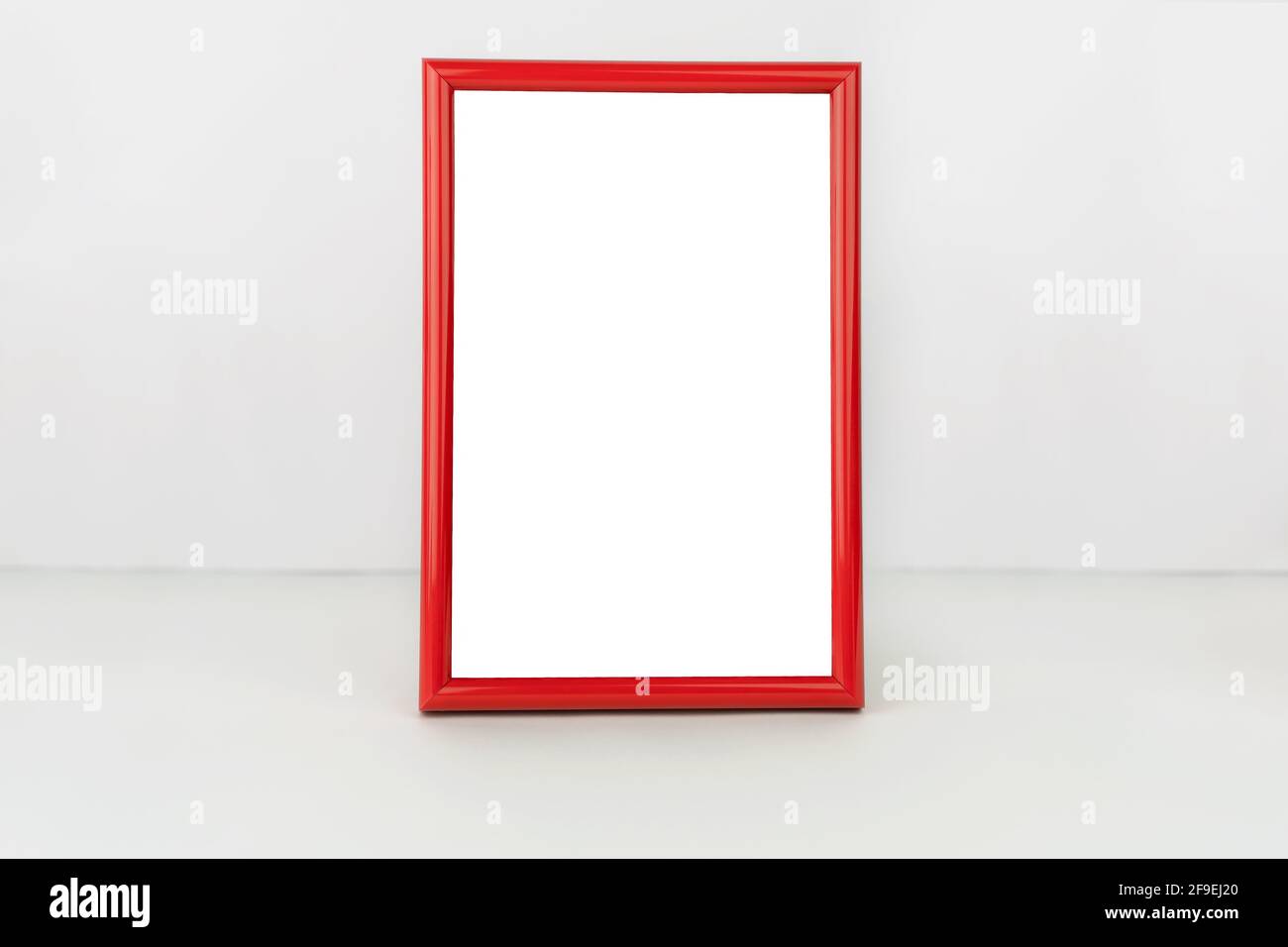 Red vertical frame on table. Isolated white background. Place for your ...