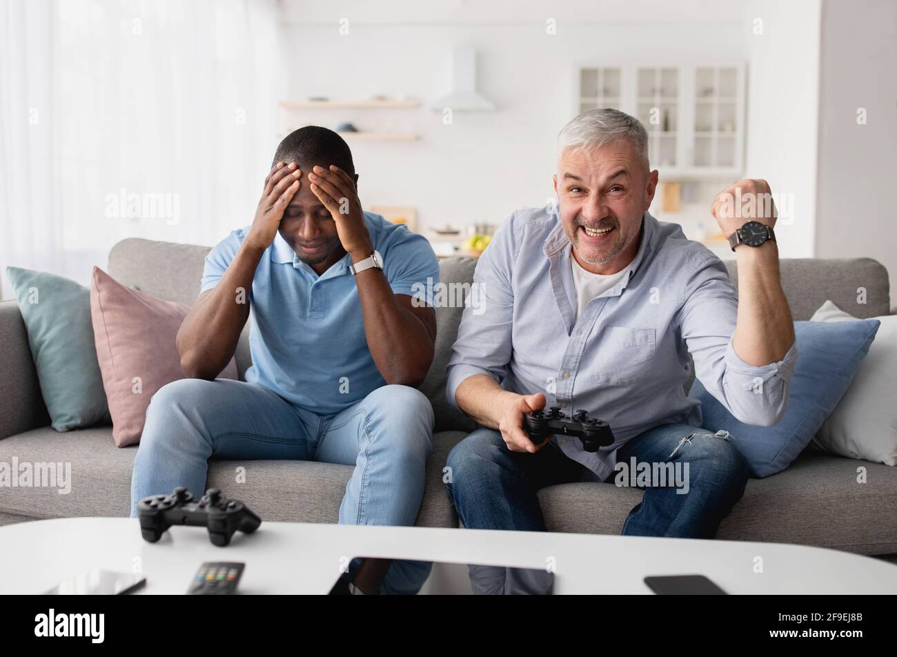 Emotions of people, victory and loss in online game at home with friend ...