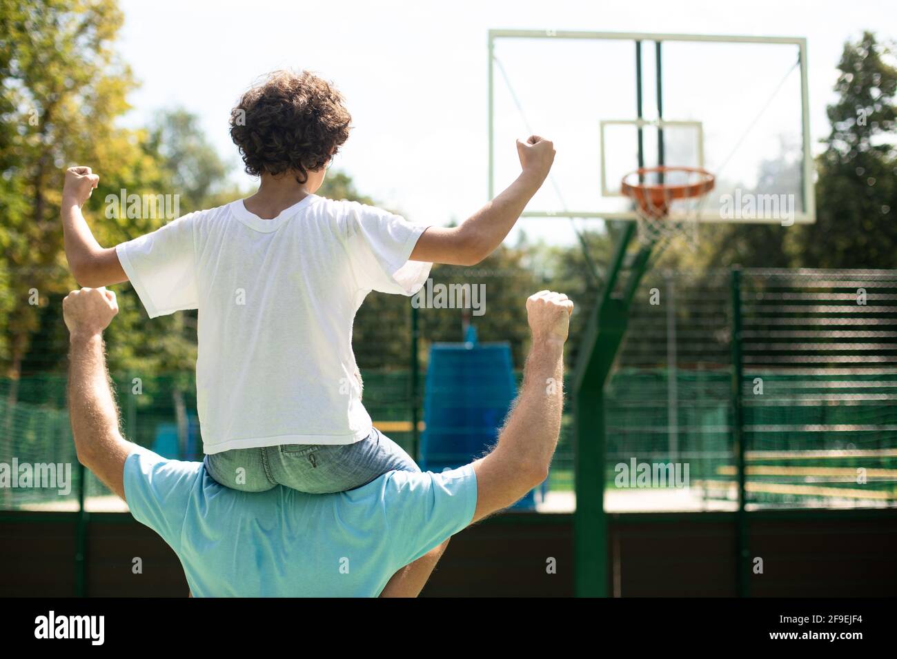 Dad and boy playing basketball on stadium and cheering Stock Photo - Alamy