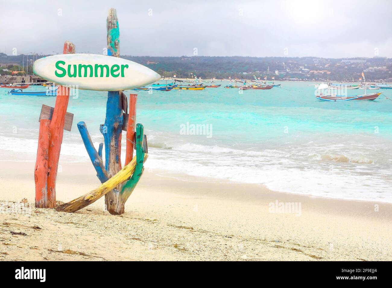 Sandy shore of blue ocean and surfboard signpost -summer. Beach of Bali ...