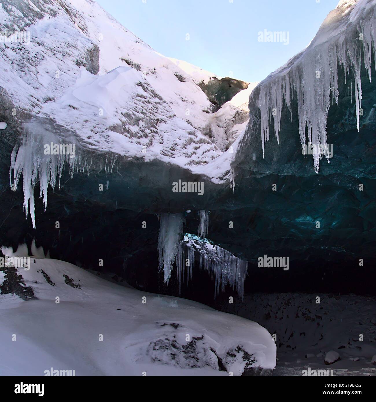 View of a big moulin hole with icicles hanging down on ceiling of the ...