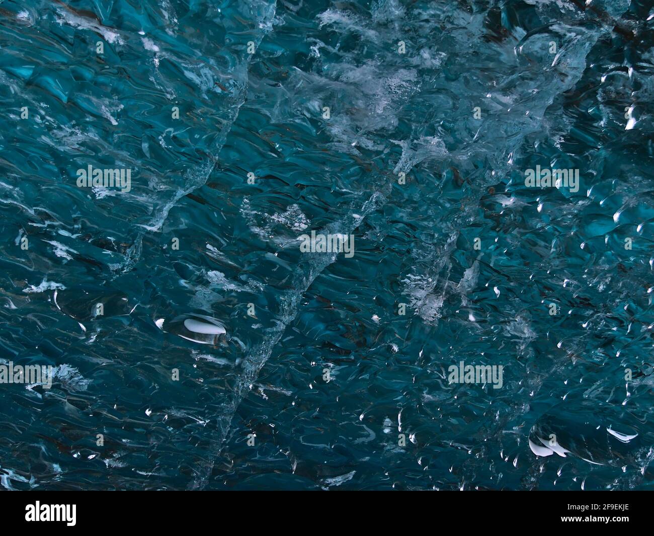 Closeup view of the transparent, blue shining ice surface on the smooth ...