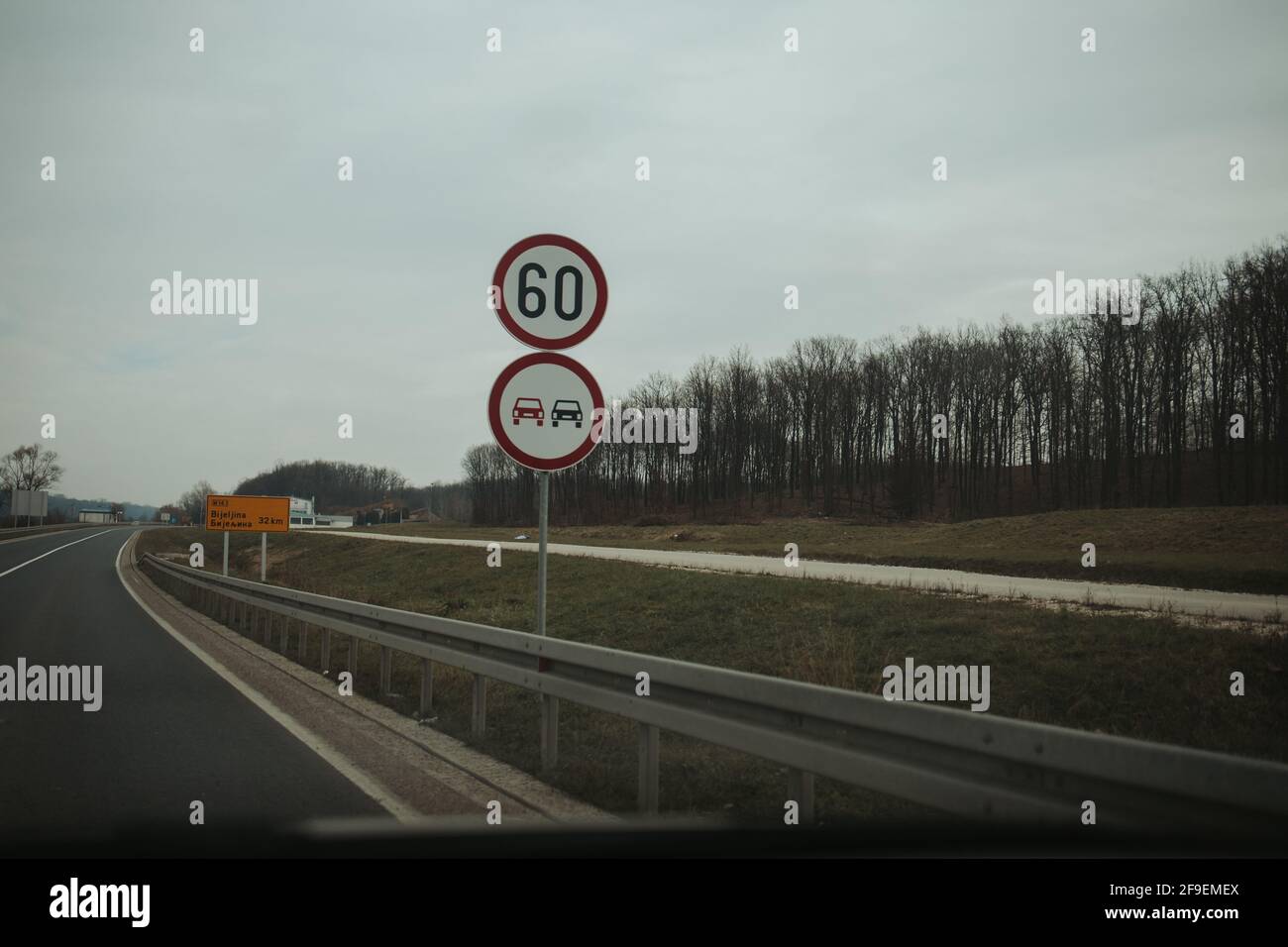 A highway with a speed limit sign "60 km per hour Stock Photo - Alamy