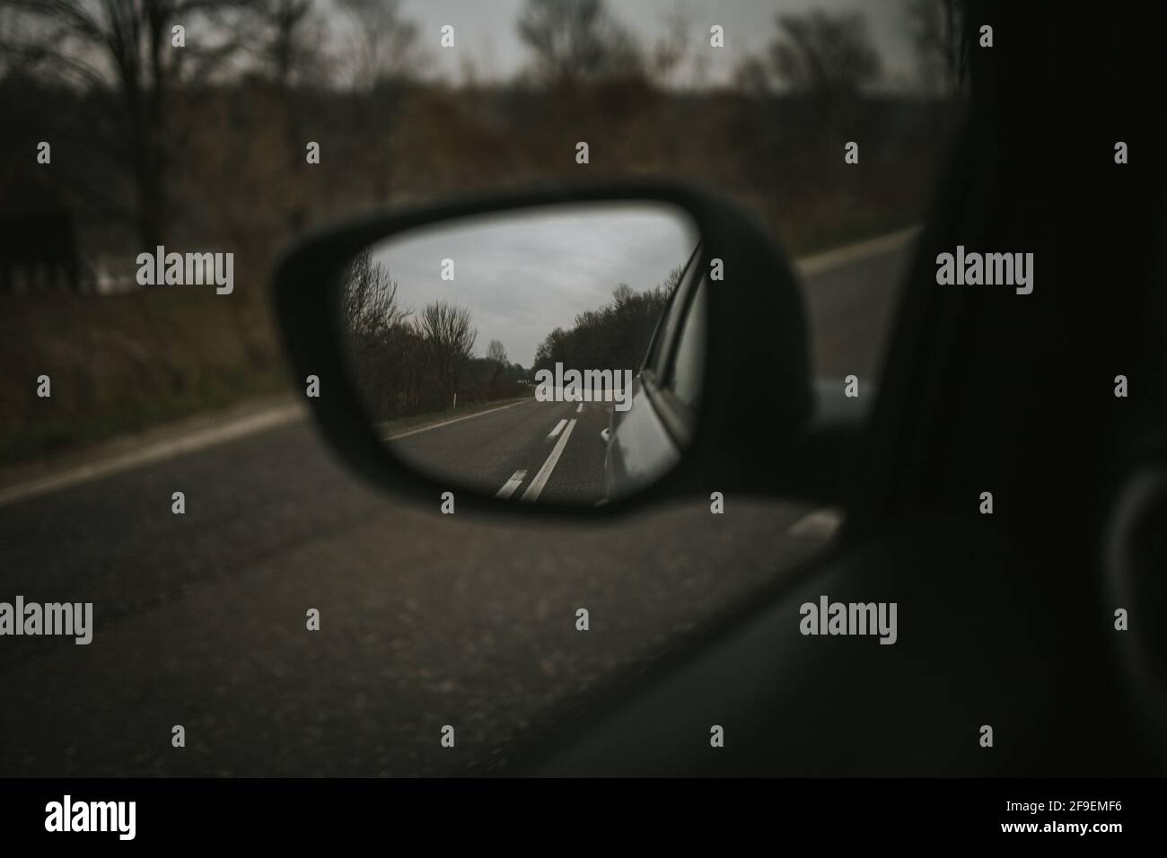 The reflection of a highway in the left side rear view mirror Stock ...