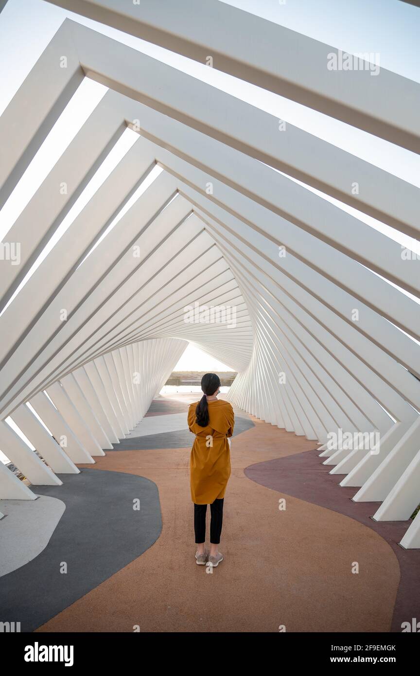 Woman walking on the pedestrian footbridge back view Stock Photo - Alamy