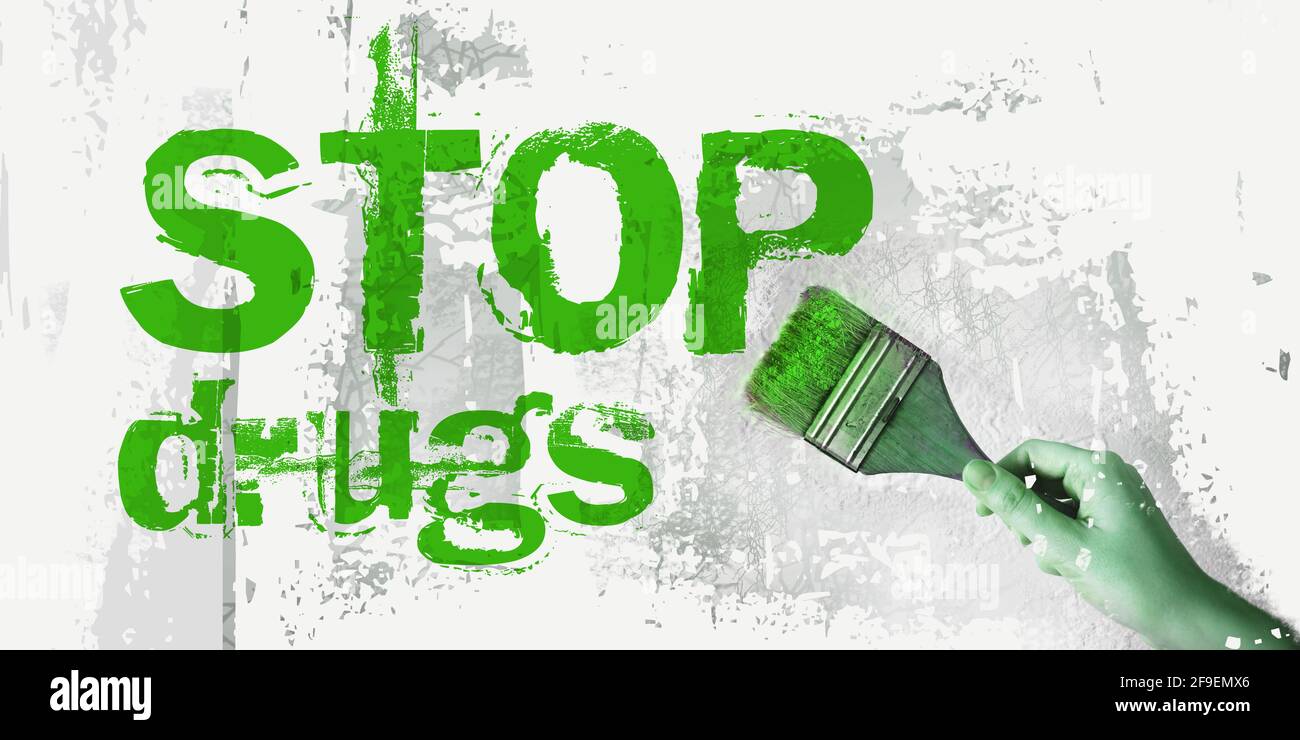 Stop drugs words Painted on light grey wall background and a hand ...