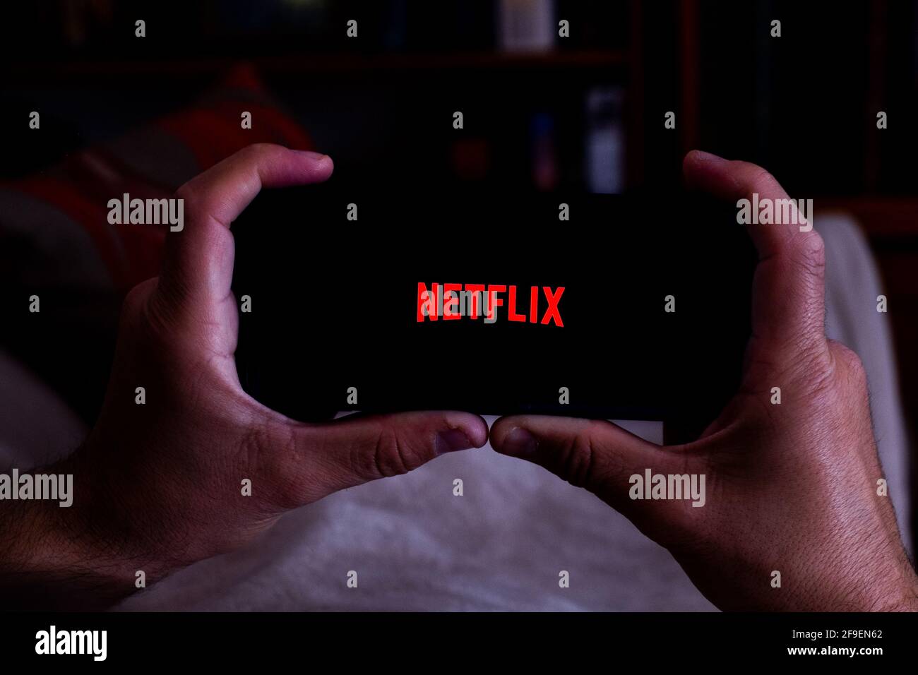 Spain. 04, 18, 2021. Close-up of a man holding a smartphone with the ...