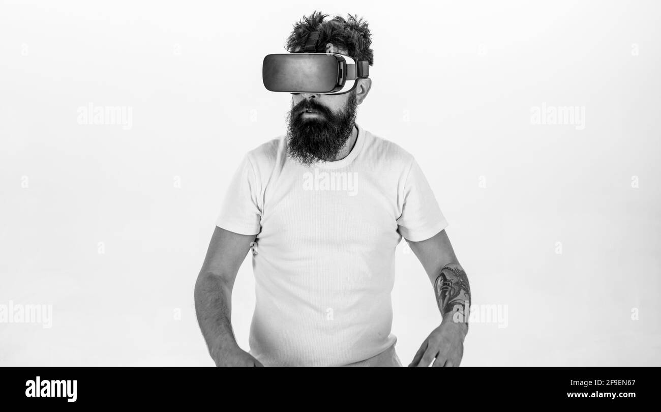 Guy with head mounted display interact in virtual reality. Hipster on strict face exploring ...