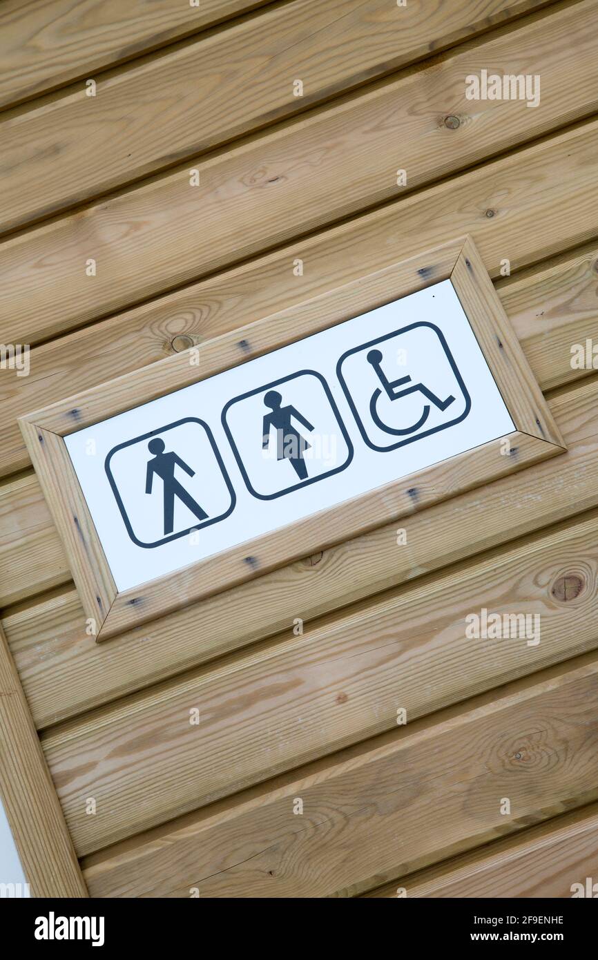 Toilet WC Sign on Wooden Background Stock Photo - Alamy