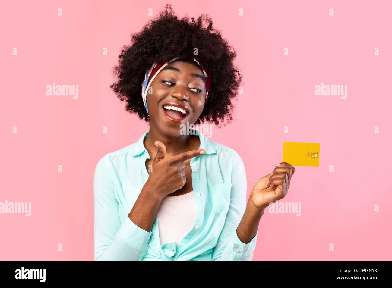 Cheerful Black Woman Pointing Finger At Credit Card In Studio Stock ...