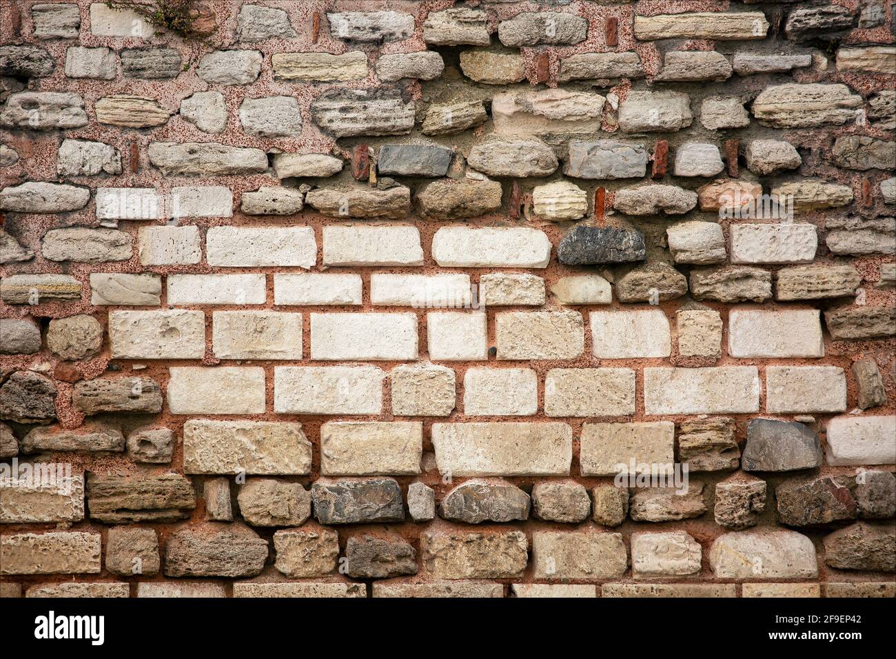 Old wall built of brick and stone, historic background Stock Photo - Alamy