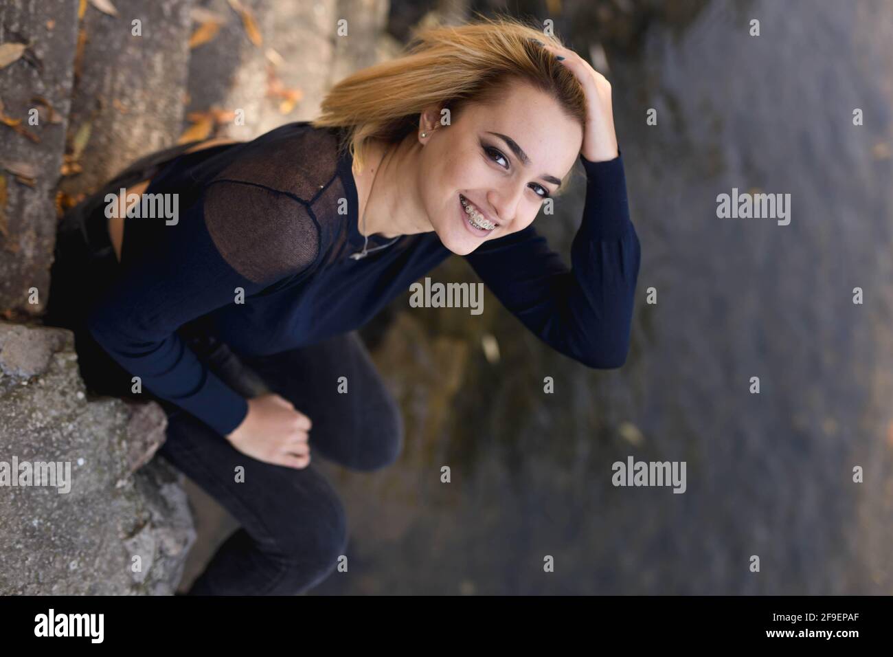 A high angle shot of blonde attractive beautiful bosnian woman sitting ...