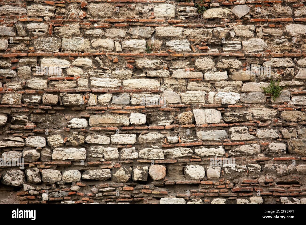 Old wall built of brick and stone, historic background Stock Photo - Alamy