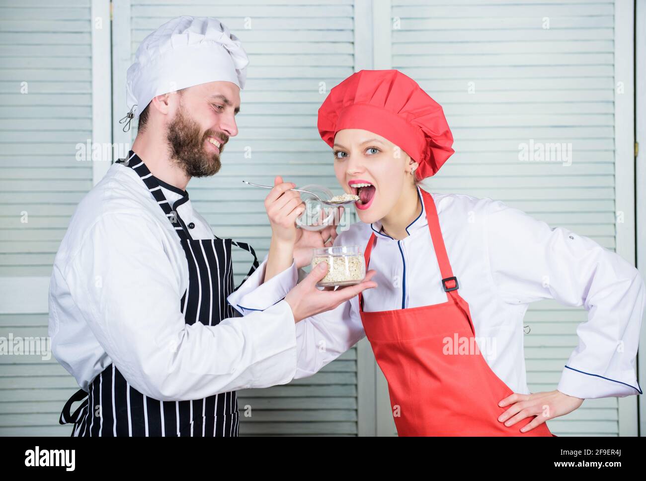 Happy married couple have joy together at kitchen. secret ingredient by ...