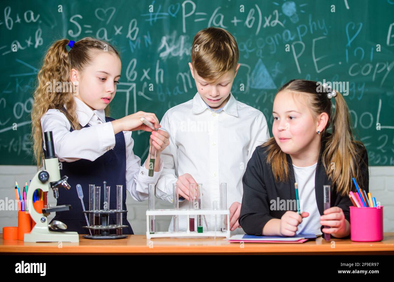 Test tubes with substances. Formal education. Girls and boy student ...