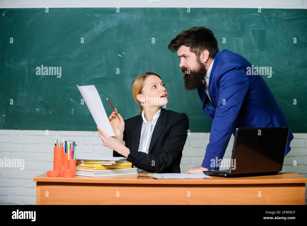 Teacher and supervisor working together in school classroom ...