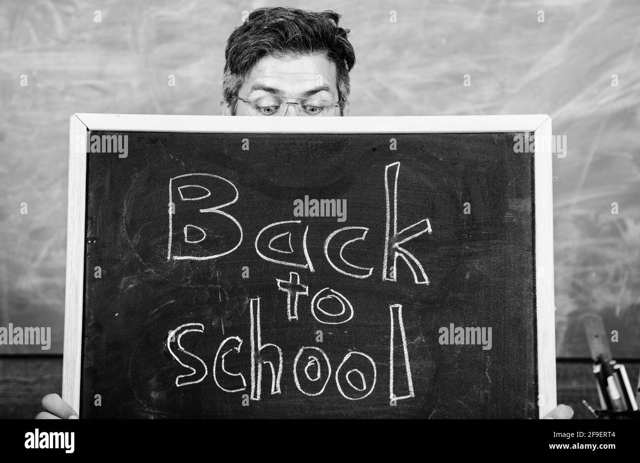 Teacher or school principal welcomes inscription back to school ...