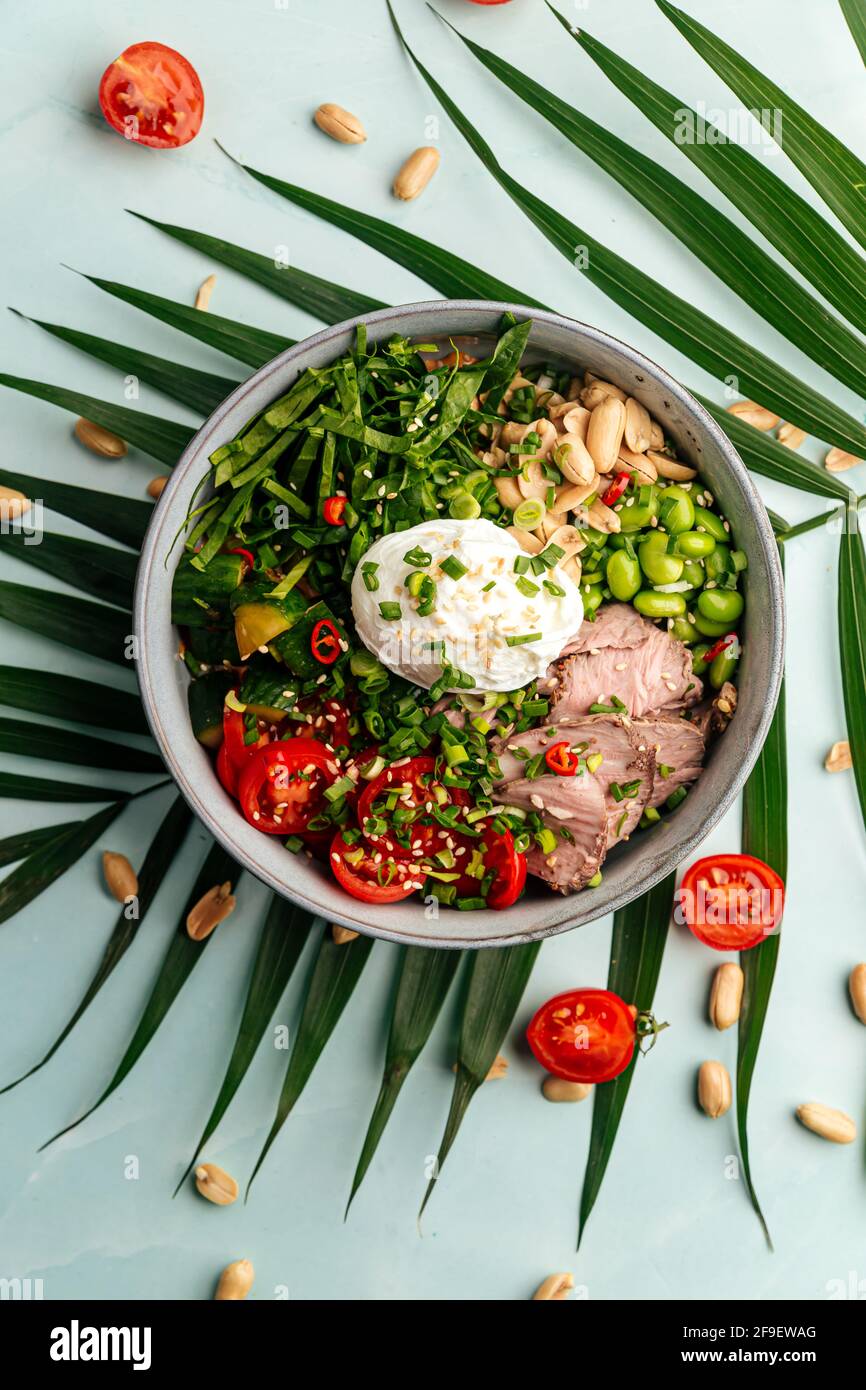 Roast beef pokeh with poached egg and vegetables Stock Photo - Alamy