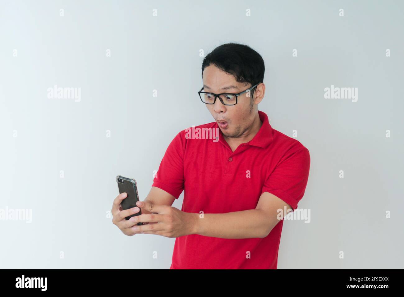 Wow face of Young Asian man shocked what he see in the smartphone on ...