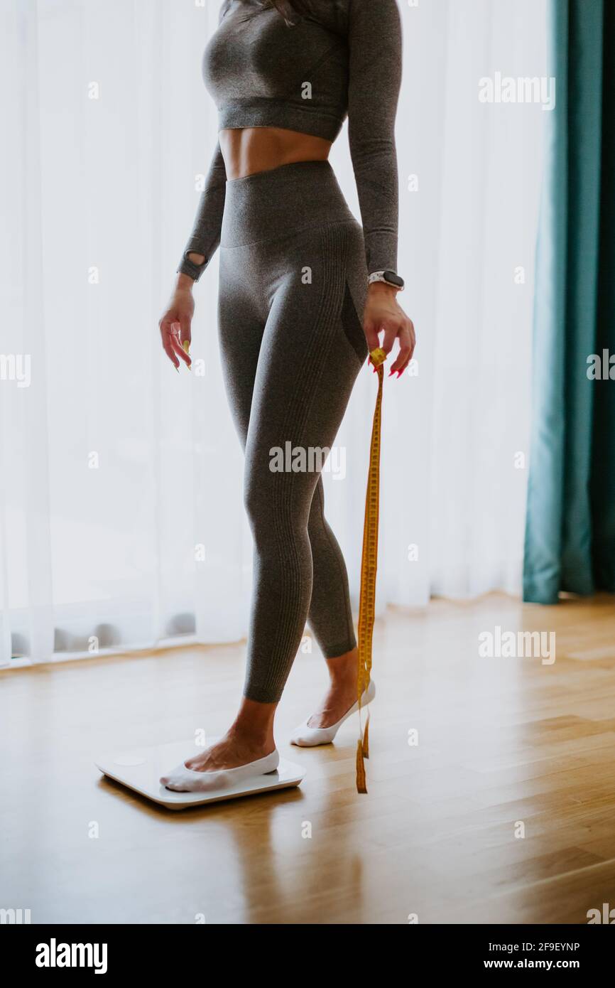 Woman step on Weighing Scale for Measuring Body Weight At Home Stock ...
