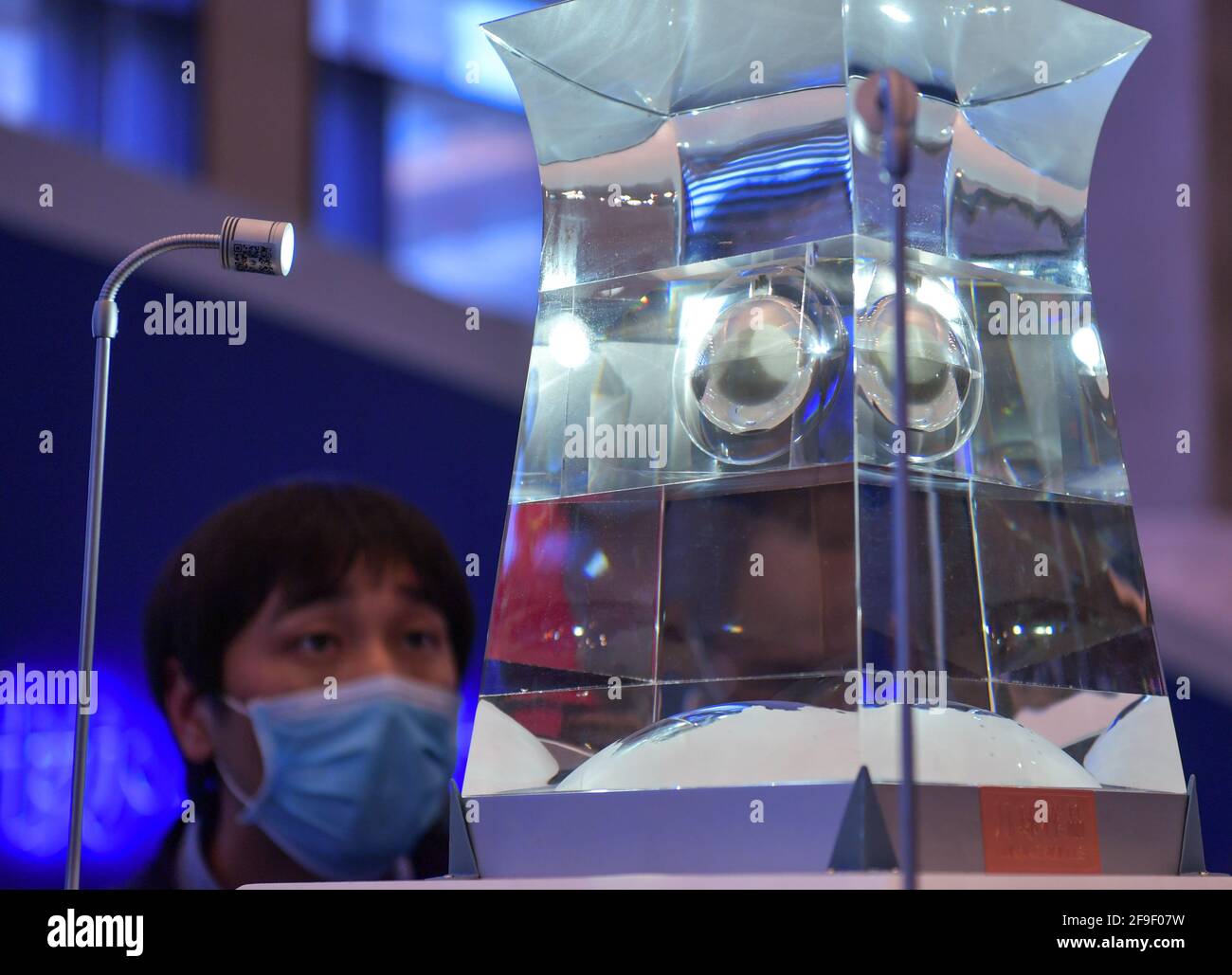 Beijing, China. 18th Apr, 2021. A visitor looks at lunar samples ...