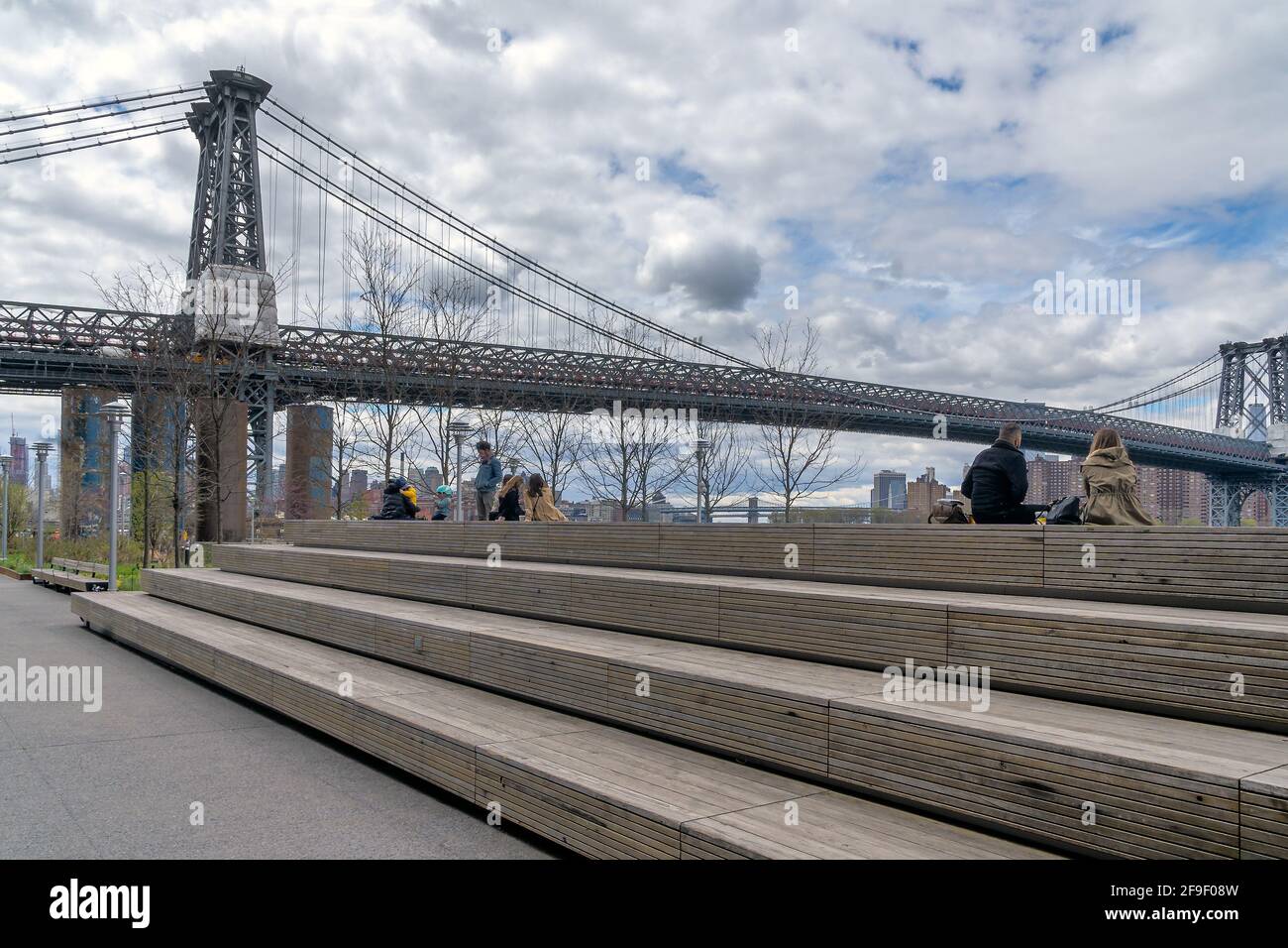 Brooklyn, NY - USA - April 17, 2021: People relaxing on Domino Park's ...