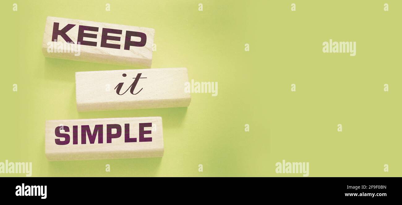 Keep it simple words on wooden blocks on dark gray background. Business ...