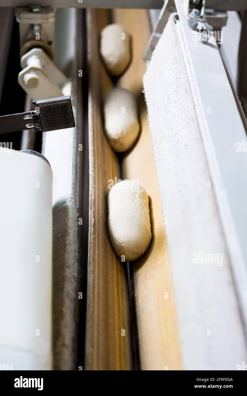 Bread dough running on conveyor belt. Food production Stock Photo - Alamy