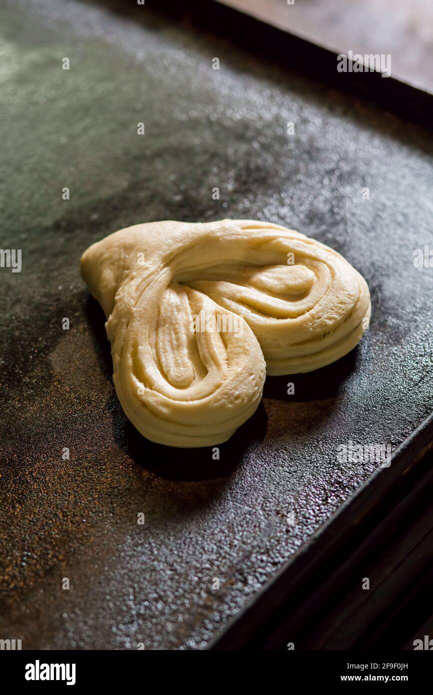 Raw dough in a heart shape. Food factory Stock Photo - Alamy