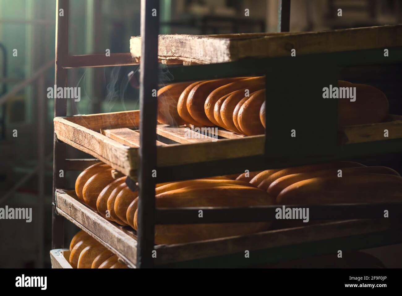 Freshly baked bread on rack. Pastry products at bakery Stock Photo - Alamy
