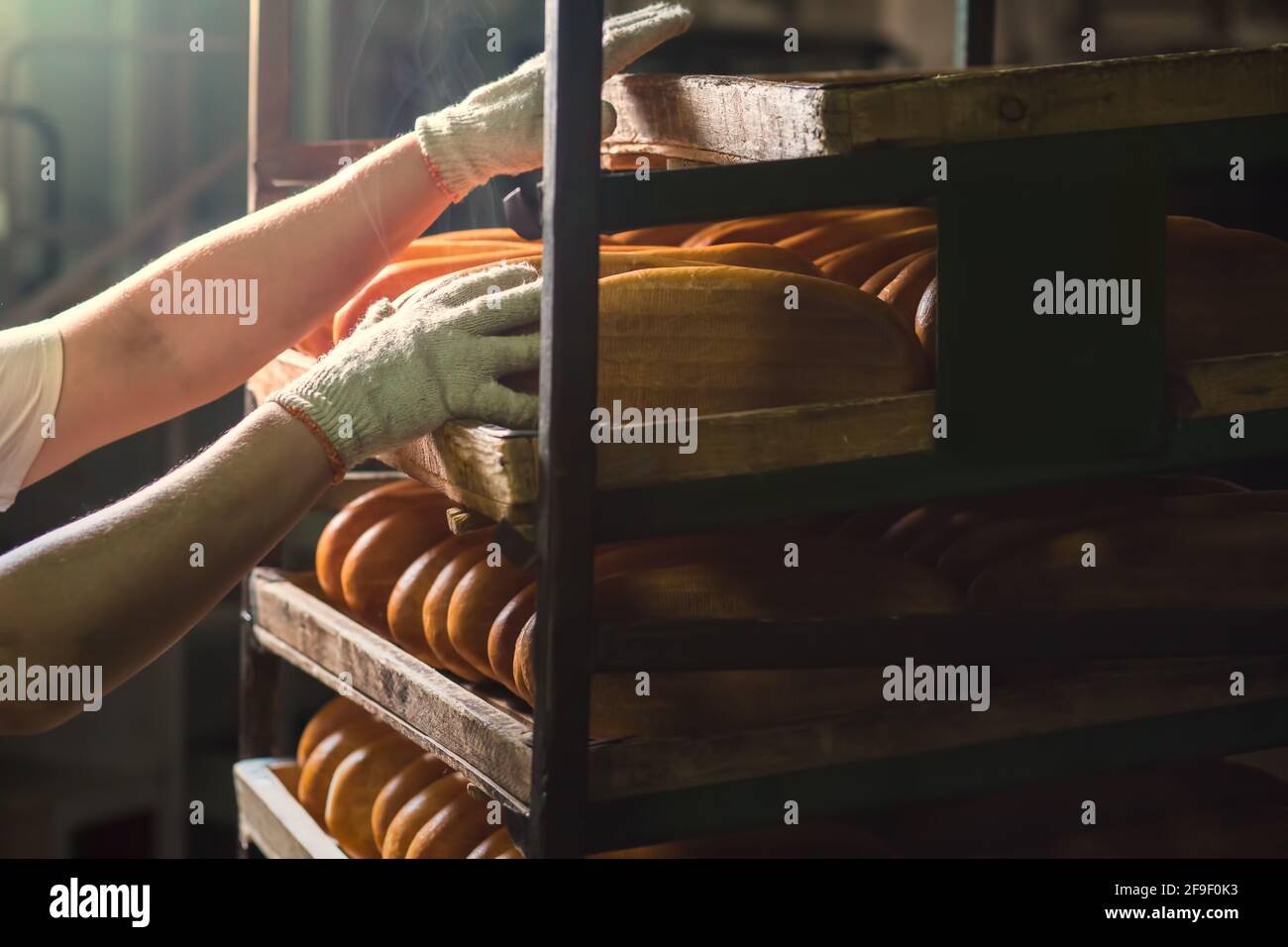 Worker puts fresh bread hi-res stock photography and images - Alamy