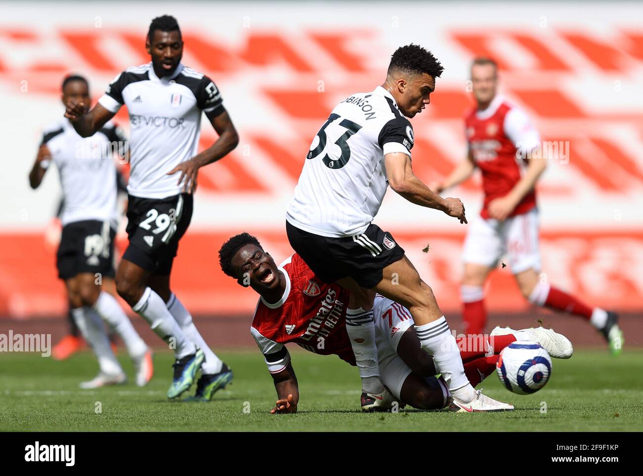 Fulham's Antonee Robinson challenges Arsenal's Bukayo Saka during the Premier League match at ...