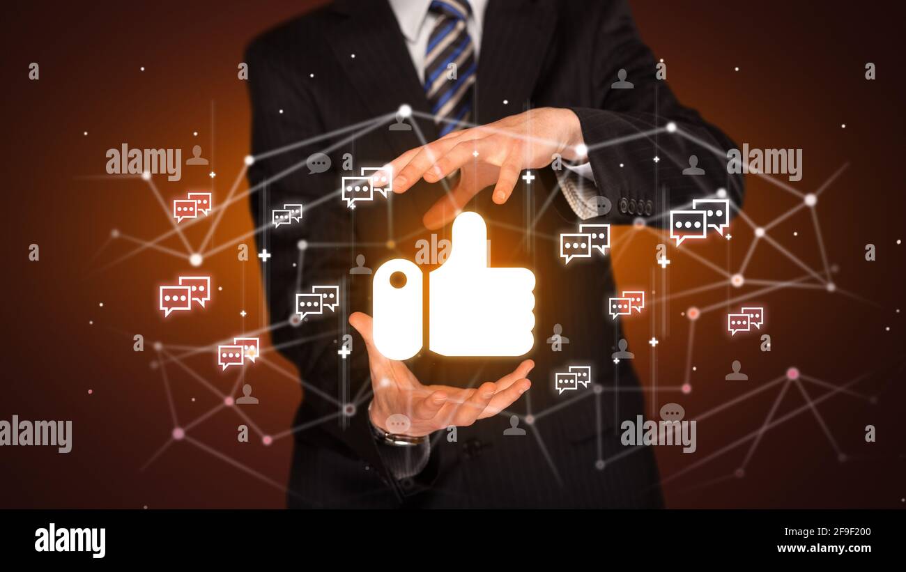 Hand holding social media icons Stock Photo - Alamy