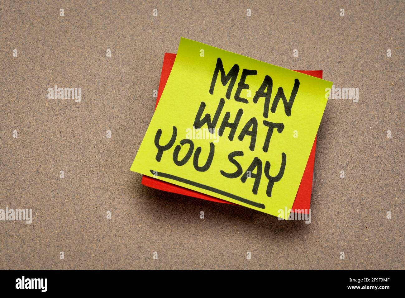 Mean what you say advice or reminder, handwriting on a sticky note ...